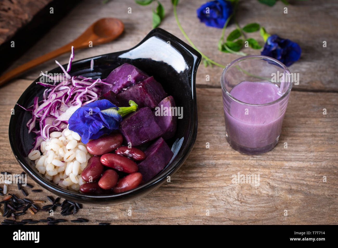 Purple vegetable salad in black bowl placed on the wood table there are ...