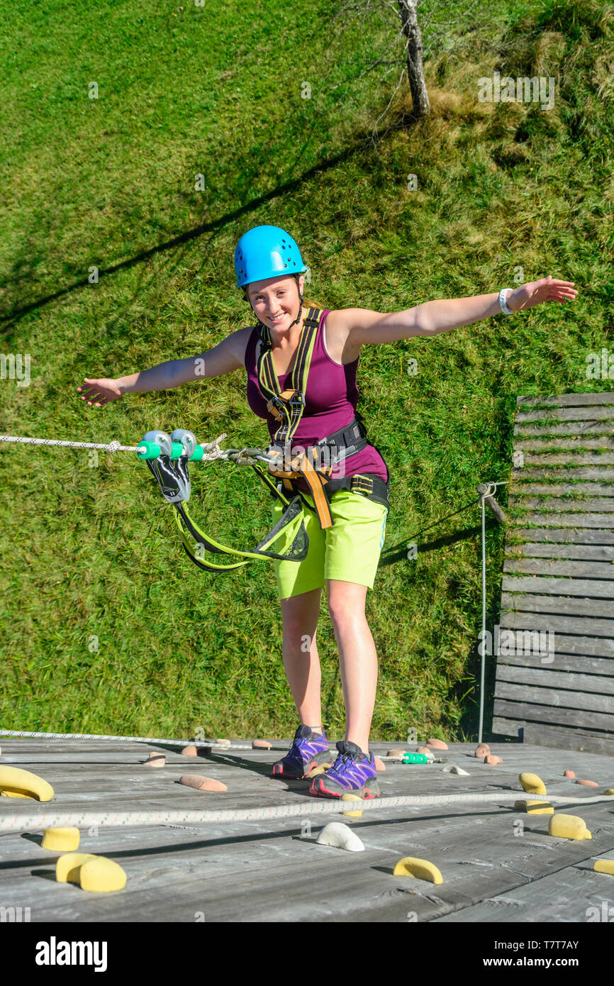 Fearless woman during abseiling training at climbing wall Stock Photo ...