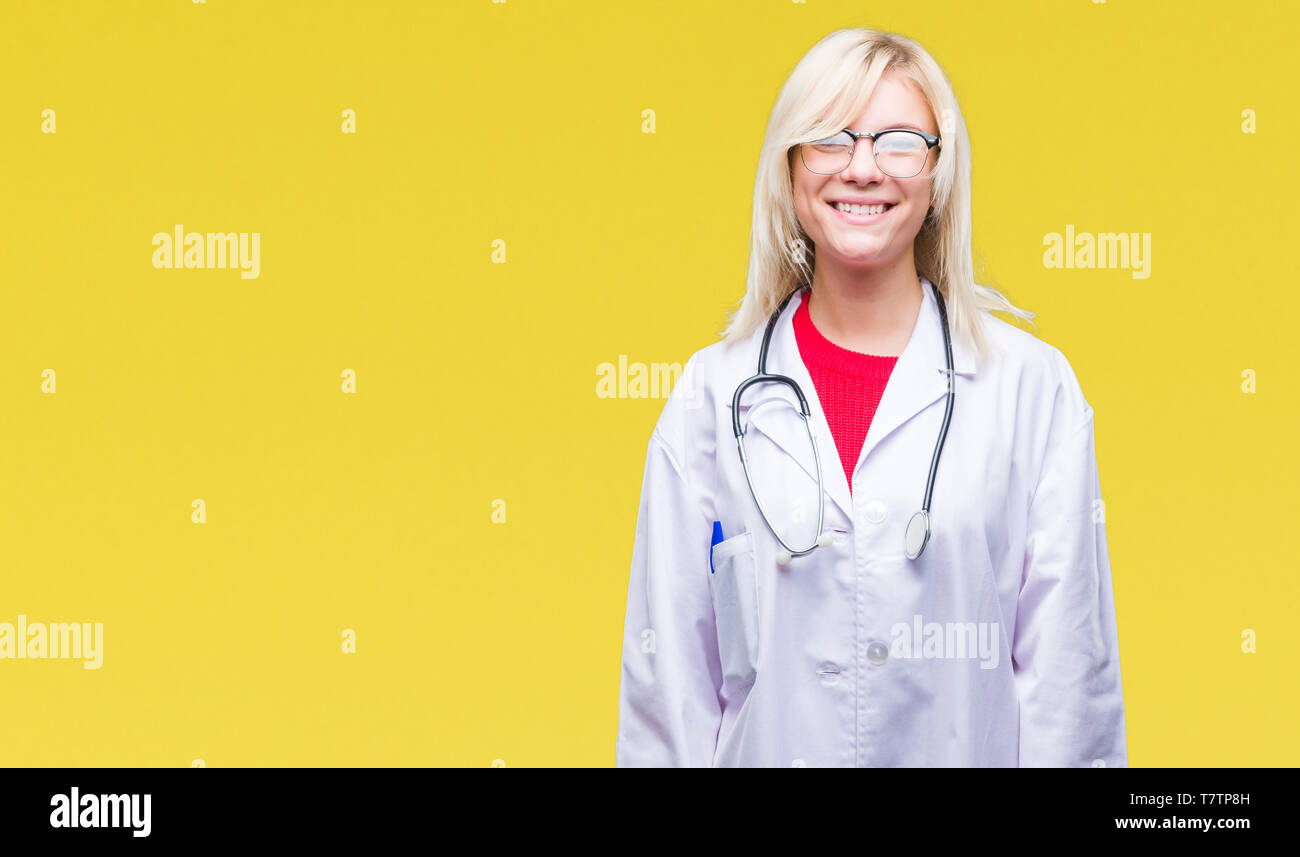 Young beautiful blonde doctor woman wearing medical uniform over ...