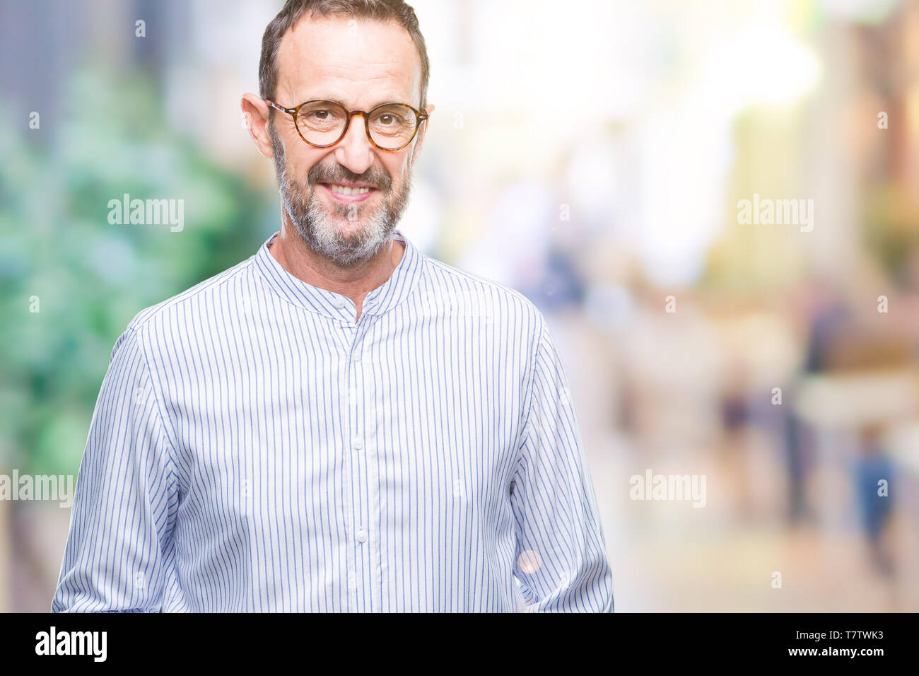 Middle age hoary senior man wearing glasses over isolated background ...