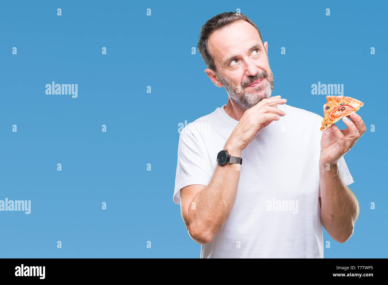 Middle age hoary senior man eating pizza slice over isolated background ...