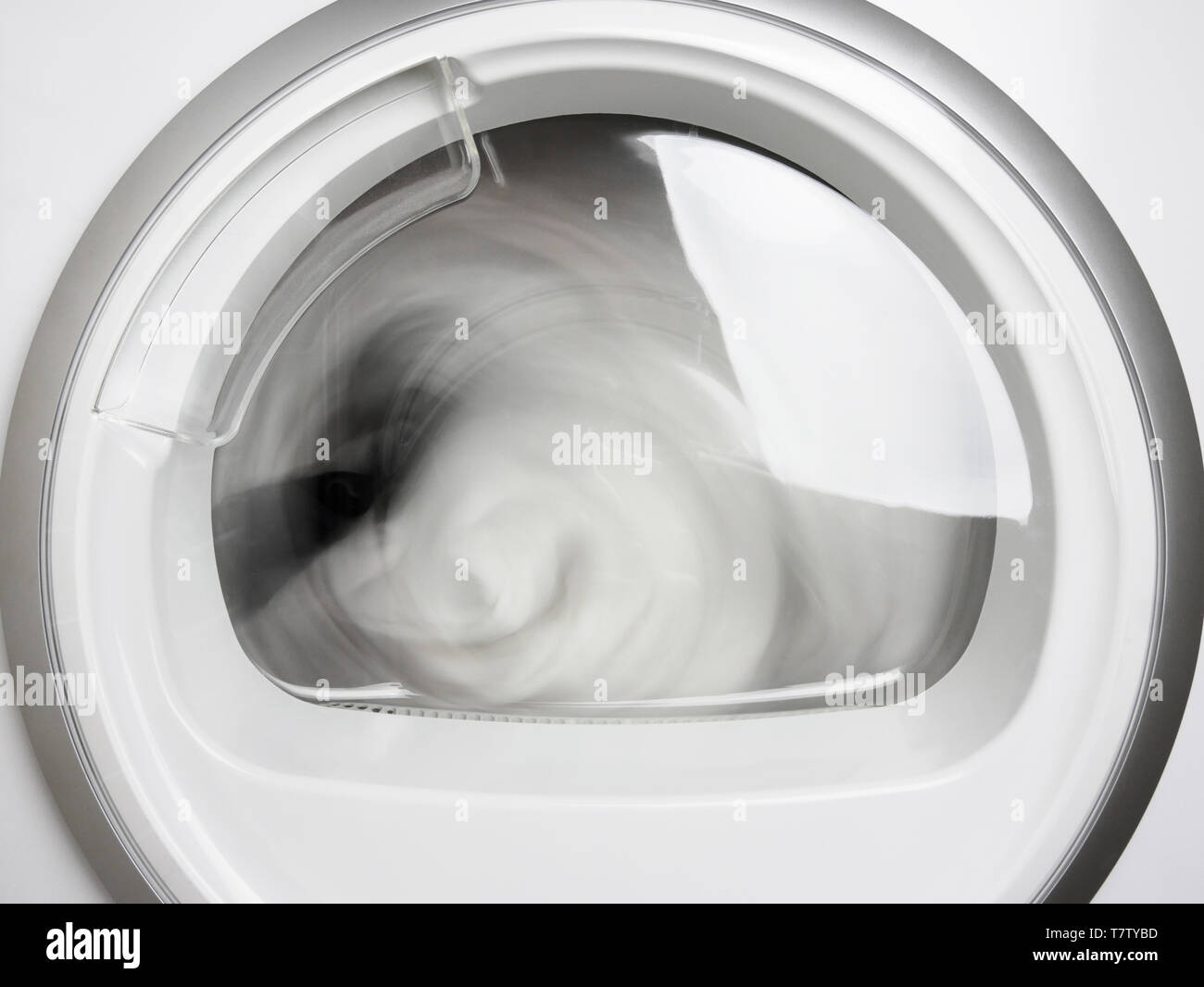 washing machine porthole closeup working front view Stock Photo - Alamy