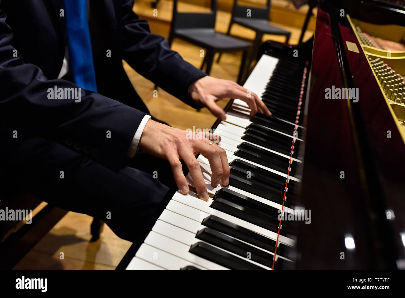 Male pianist playing classical music on a grand piano Stock Photo - Alamy