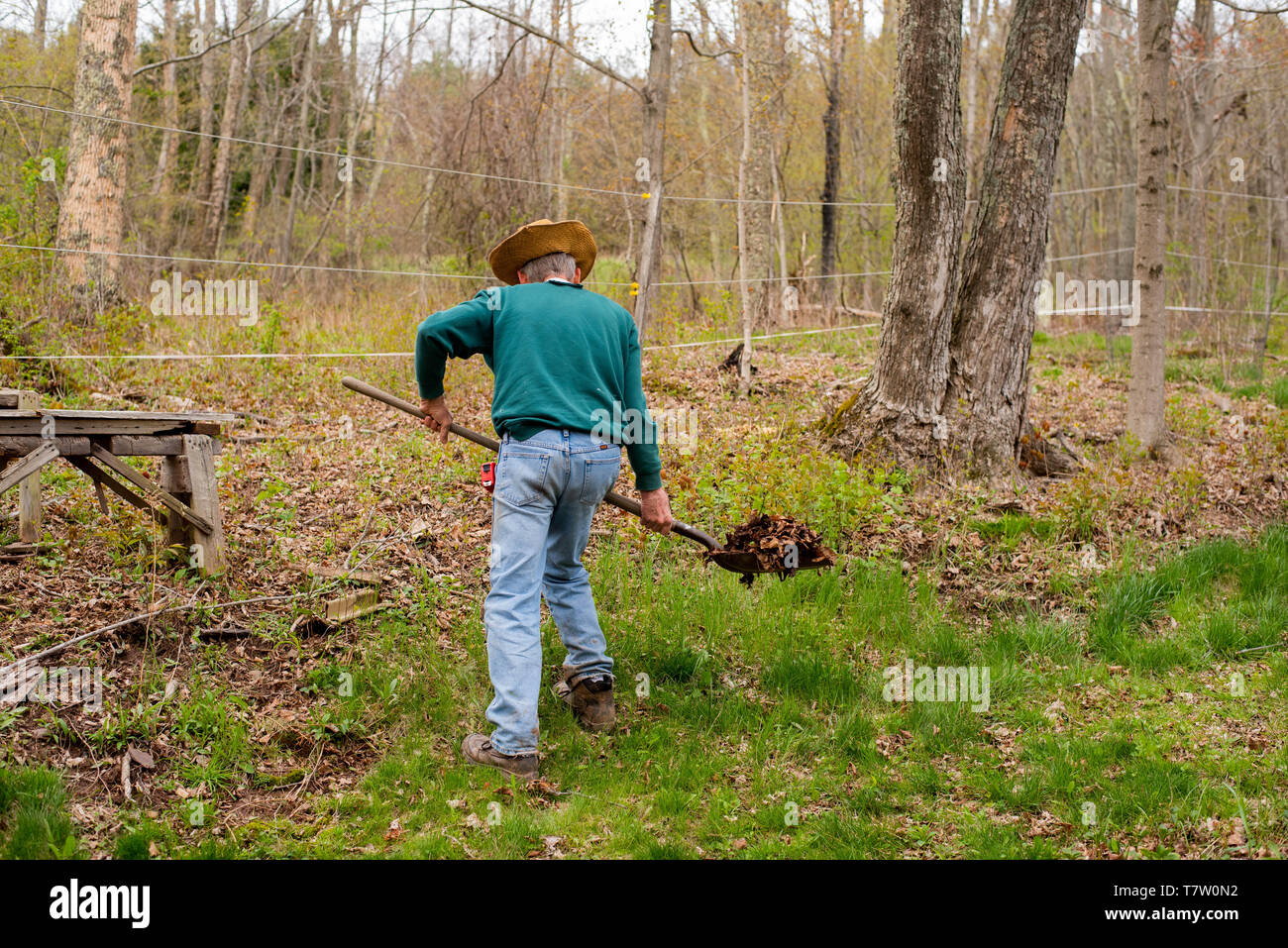 Elderly man digging up soil hi-res stock photography and images - Alamy