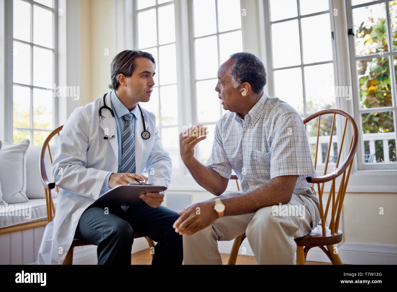 Concerned senior man talking over healthcare options with his family ... Concerned senior man talking over healthcare options with his family ...