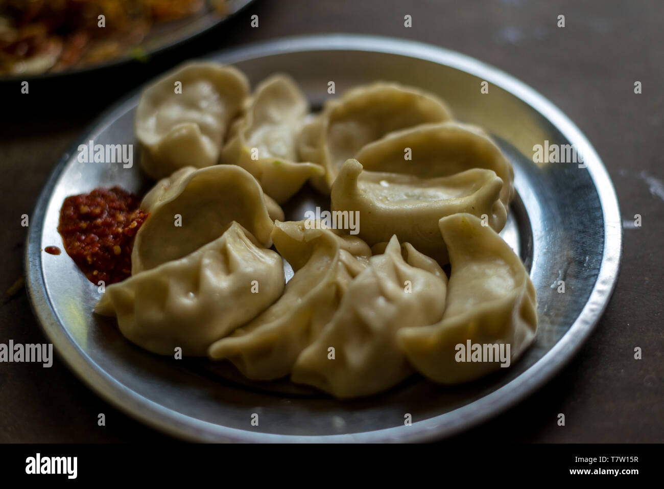 Photo of Nepalese traditional dumpling momos steamed served with tomato ...