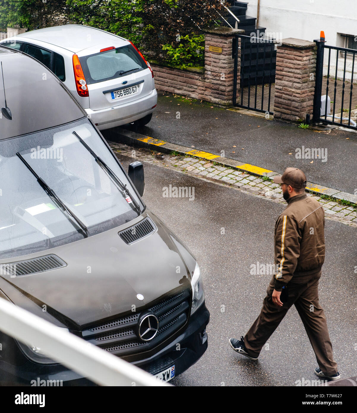 Paris, France - Apr 10, 2019: Elevated view of UPS employee walking on ...