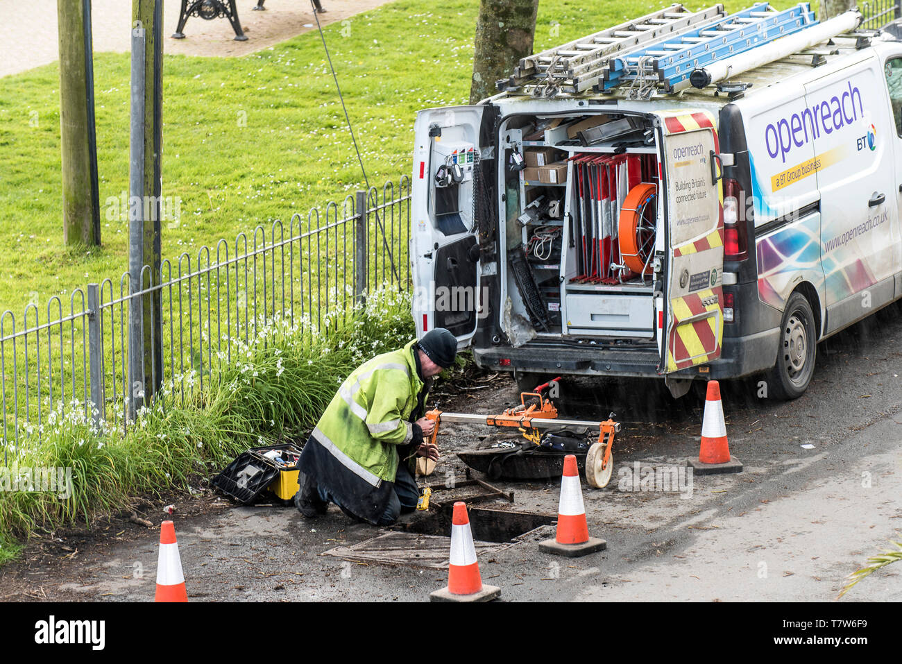 A telecommunications worker for BT Open Reach working in an access ...