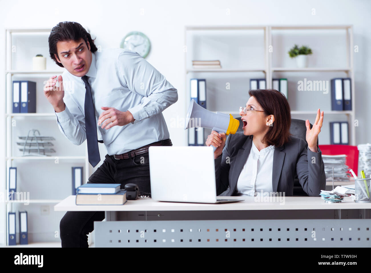 Old female boss and young male employee in the office Stock Photo - Alamy