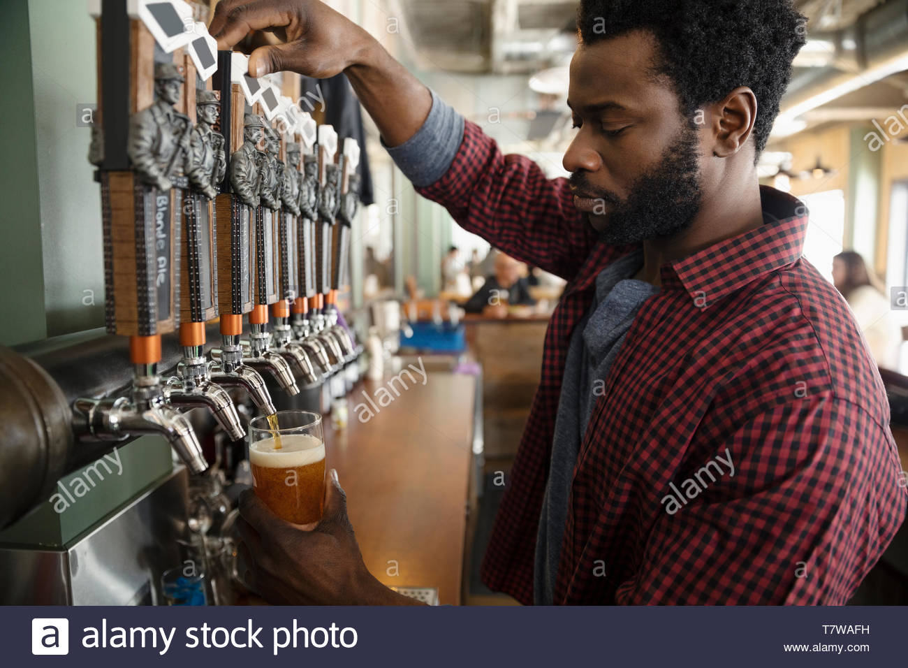 Pouring beer down the side glass hi-res stock photography and images ...