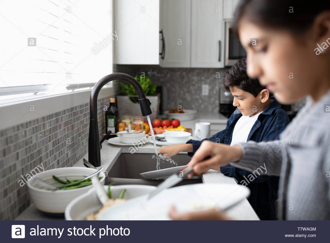 Boy washing dish hi-res stock photography and images - Alamy