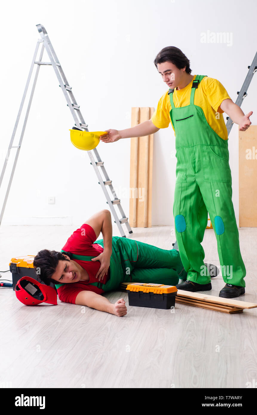 Injured worker and his workmate Stock Photo - Alamy