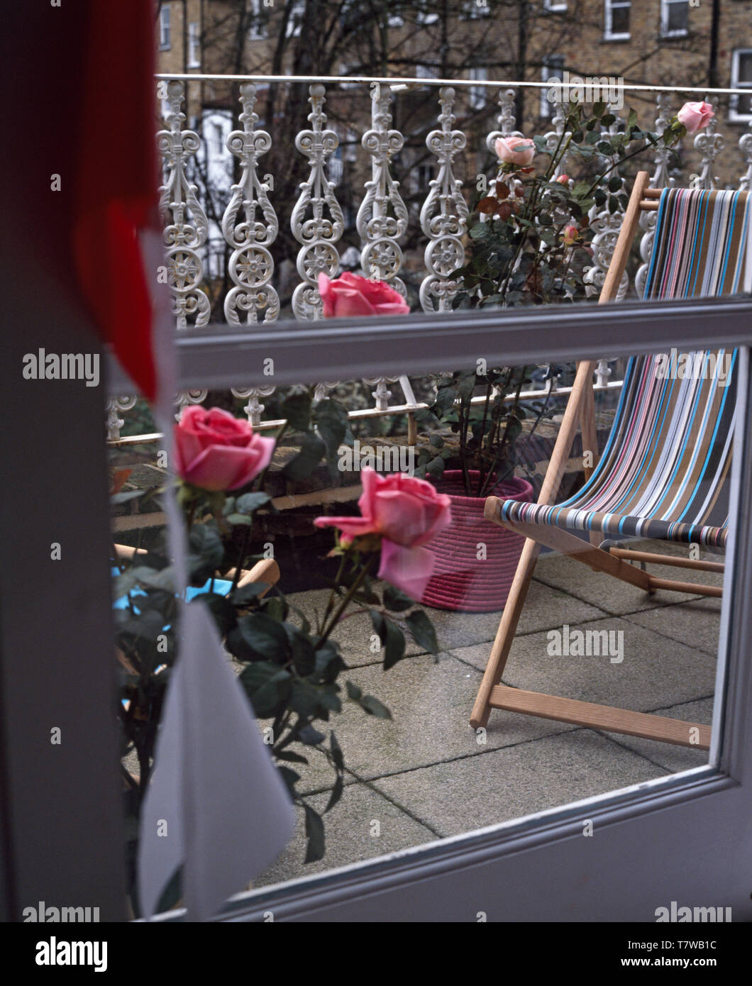 View through sash window of striped deckchair on balcony Stock Photo ...