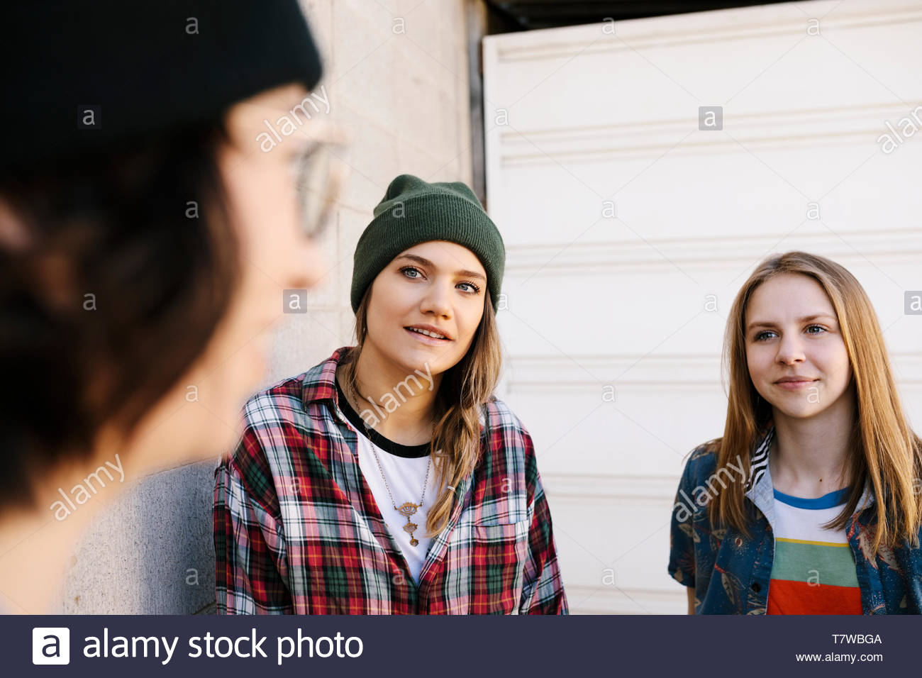 Young female friends hanging out, talking Stock Photo - Alamy