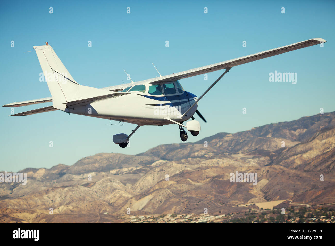 Small single engine airplane flying in the gorgeous sunset sky through ...
