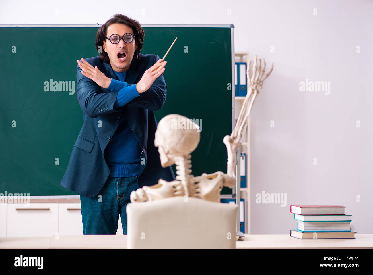 Male teacher and skeleton student in the classroom Stock Photo - Alamy
