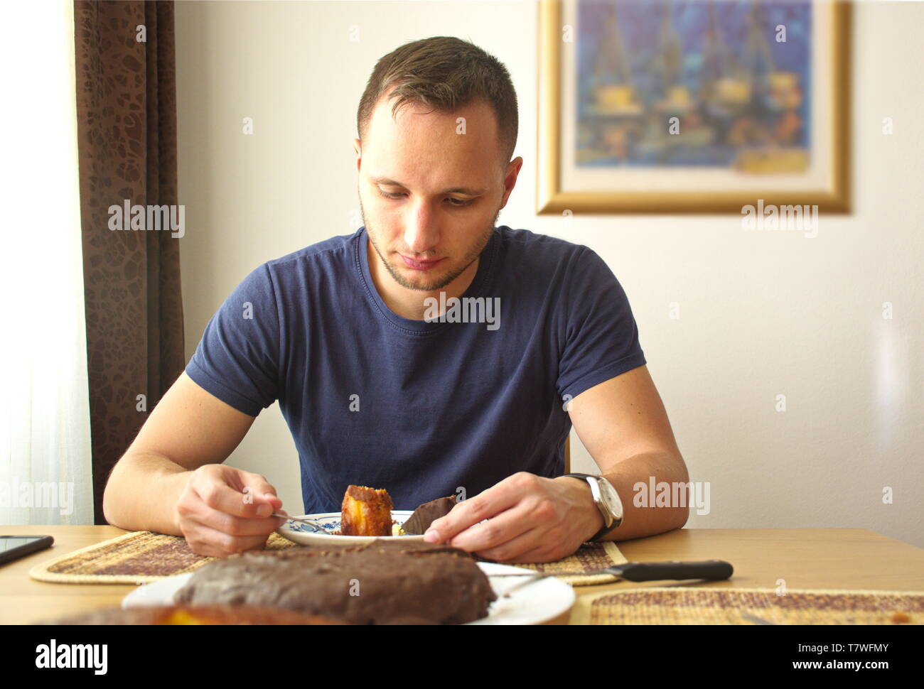 Portrait of the young man having lunch Stock Photo - Alamy