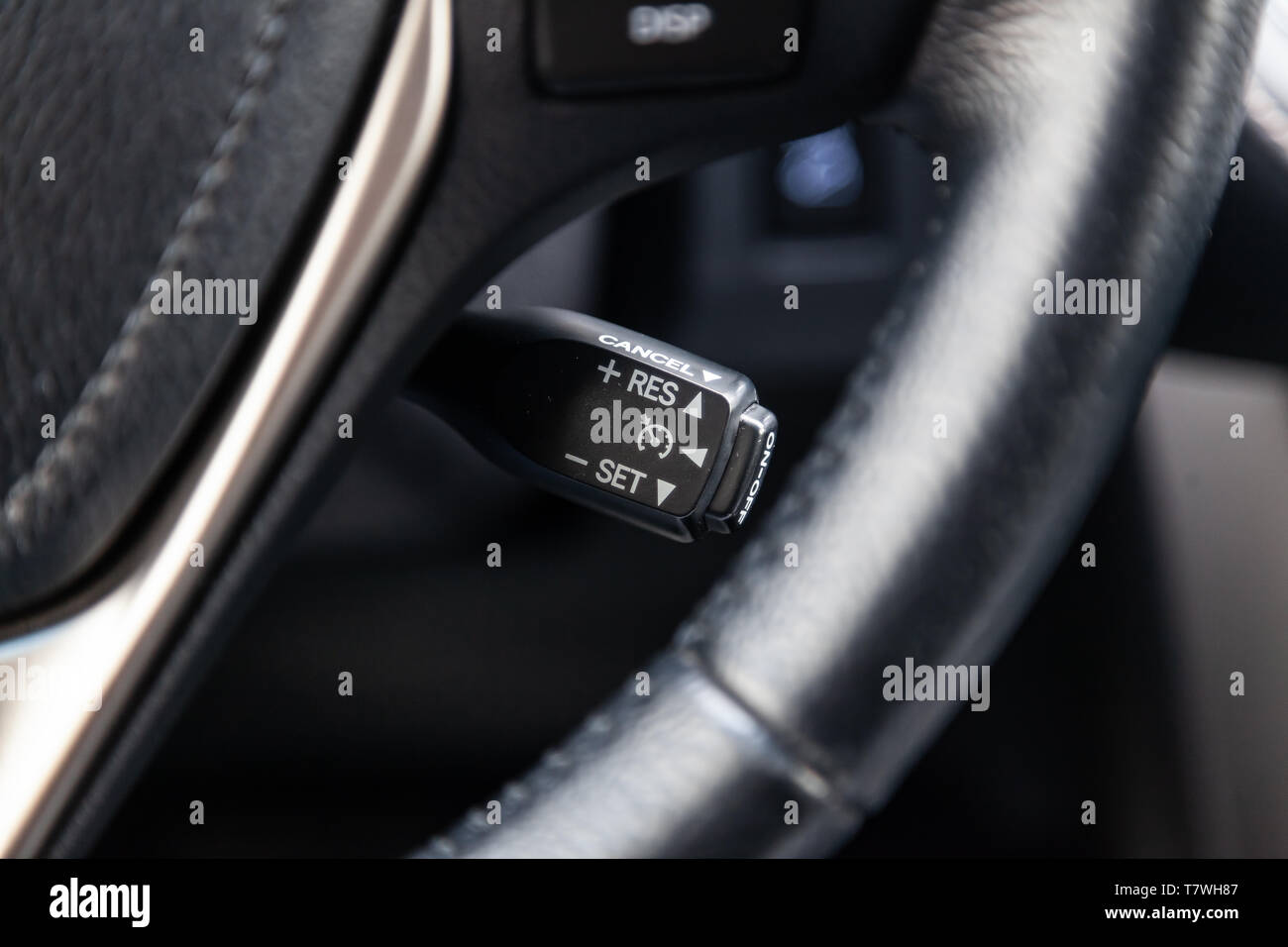 The shift lever to set the automatic cruise control speed inside the ...