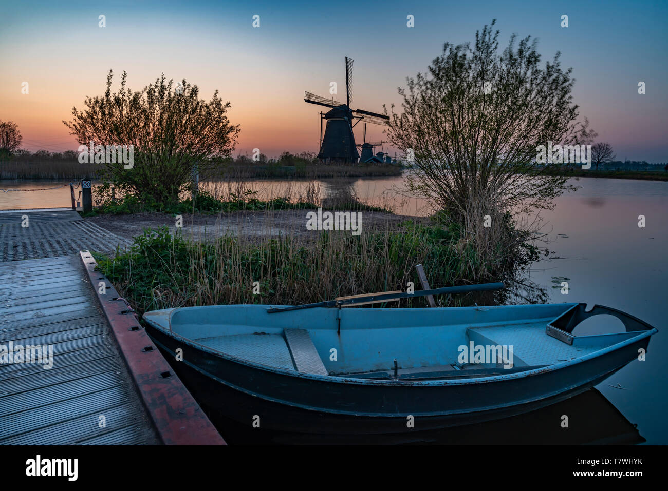 Safety boat parking at the bench of the kinderdijk canal at the golden ...