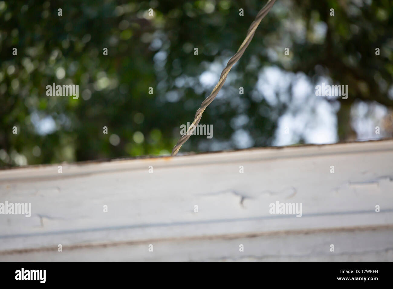 Close up of an electric wire going into a residential roof Stock Photo ...