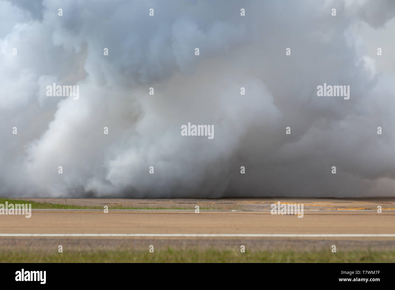 Thick smoke behind a road Stock Photo - Alamy