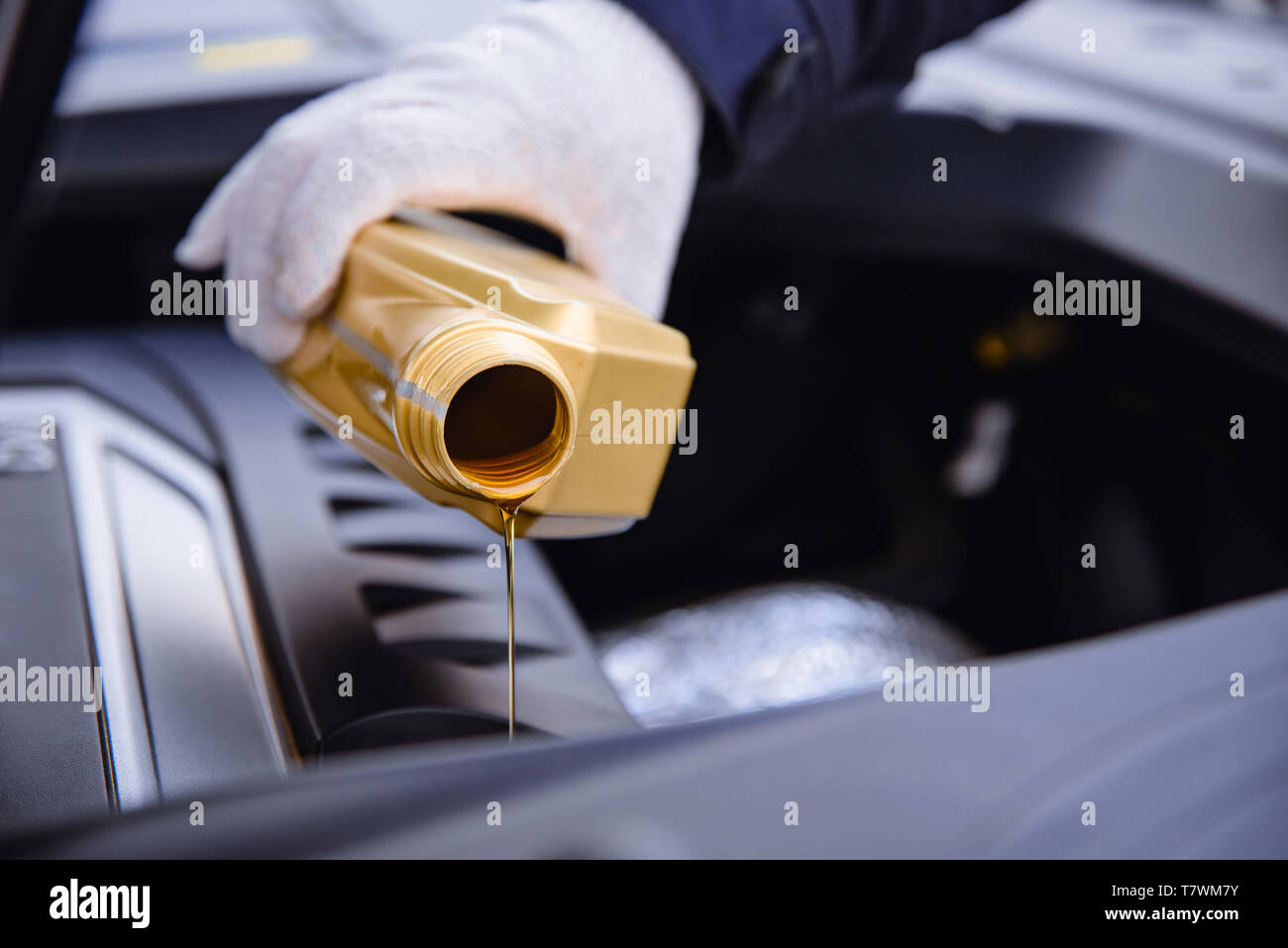 pouring engine oil into a car engine Stock Photo - Alamy