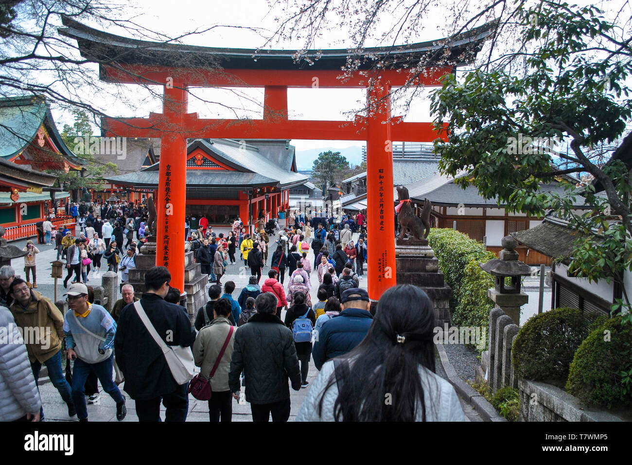 Large torii and many people leaving the Fushimi Inari shrine. Kyoto ...