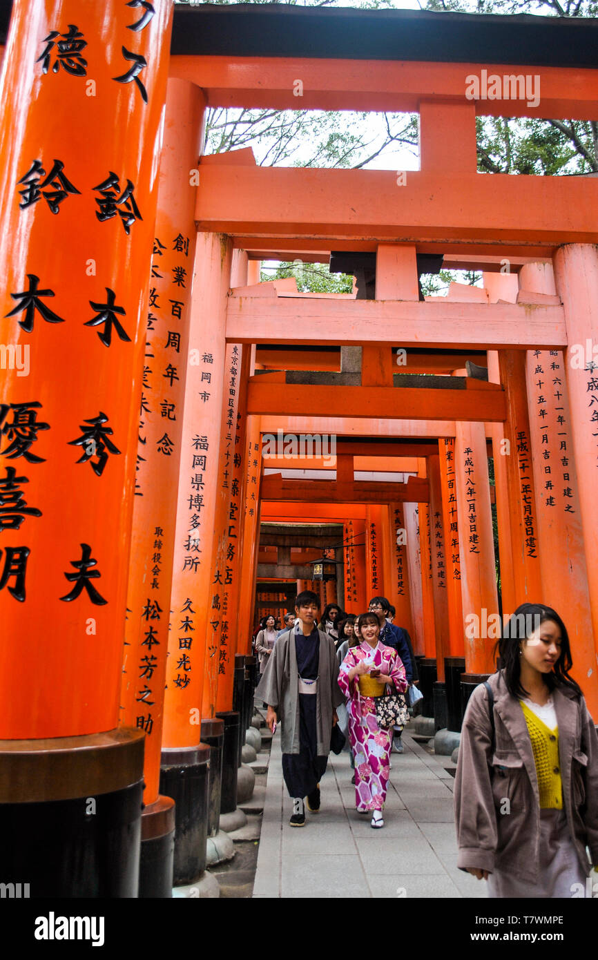People walking in the Torii path across the mountain. Fushimi Inari ...
