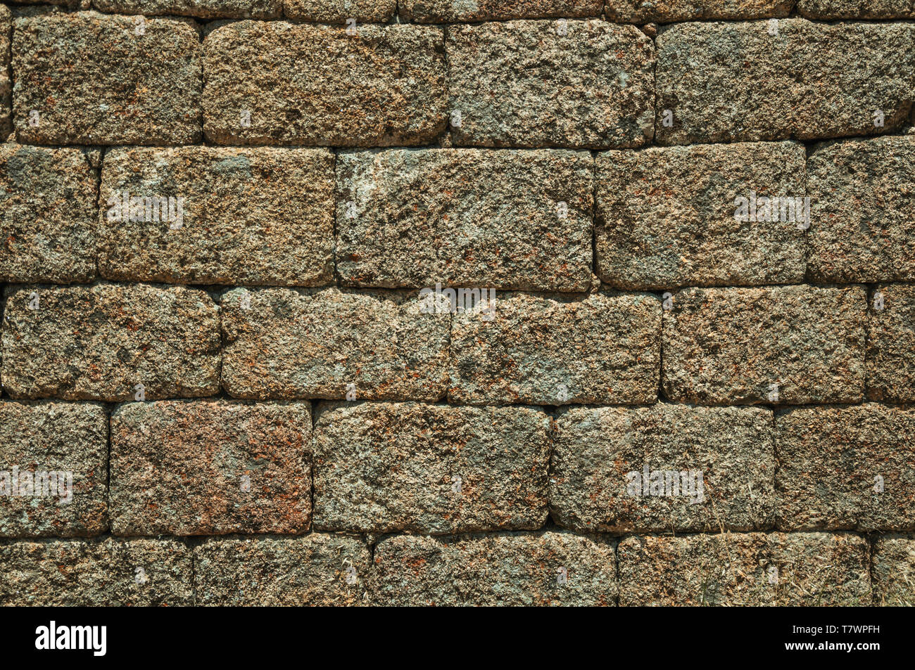 Close-up of old wall made of large stone bricks forming a charming ...
