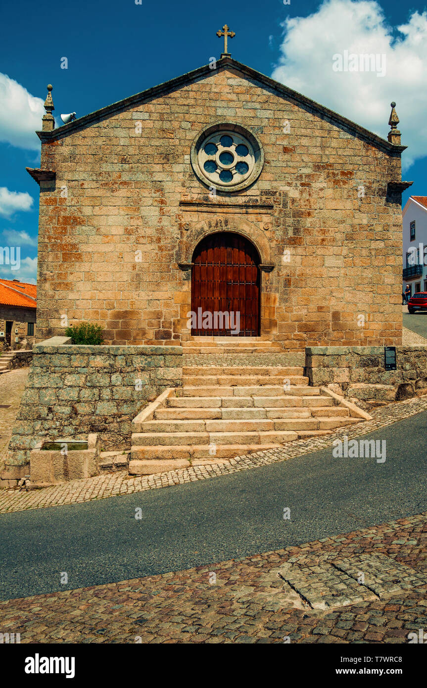 Medieval church facade with stone wall and large staircase leading to ...