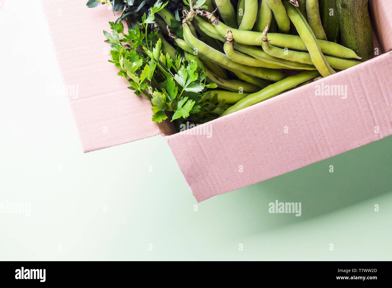 Green vegetables and herbs in cardboard box. Healthy organic food ...