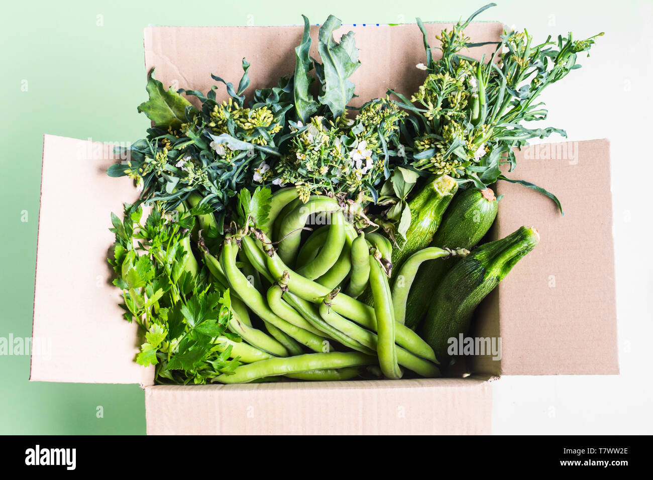 Green vegetables and herbs in cardboard box. Healthy organic food ...