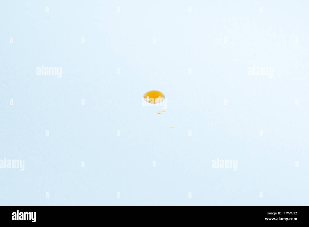 Drops of maple syrup on pastel blue background. Food abstract concept ...