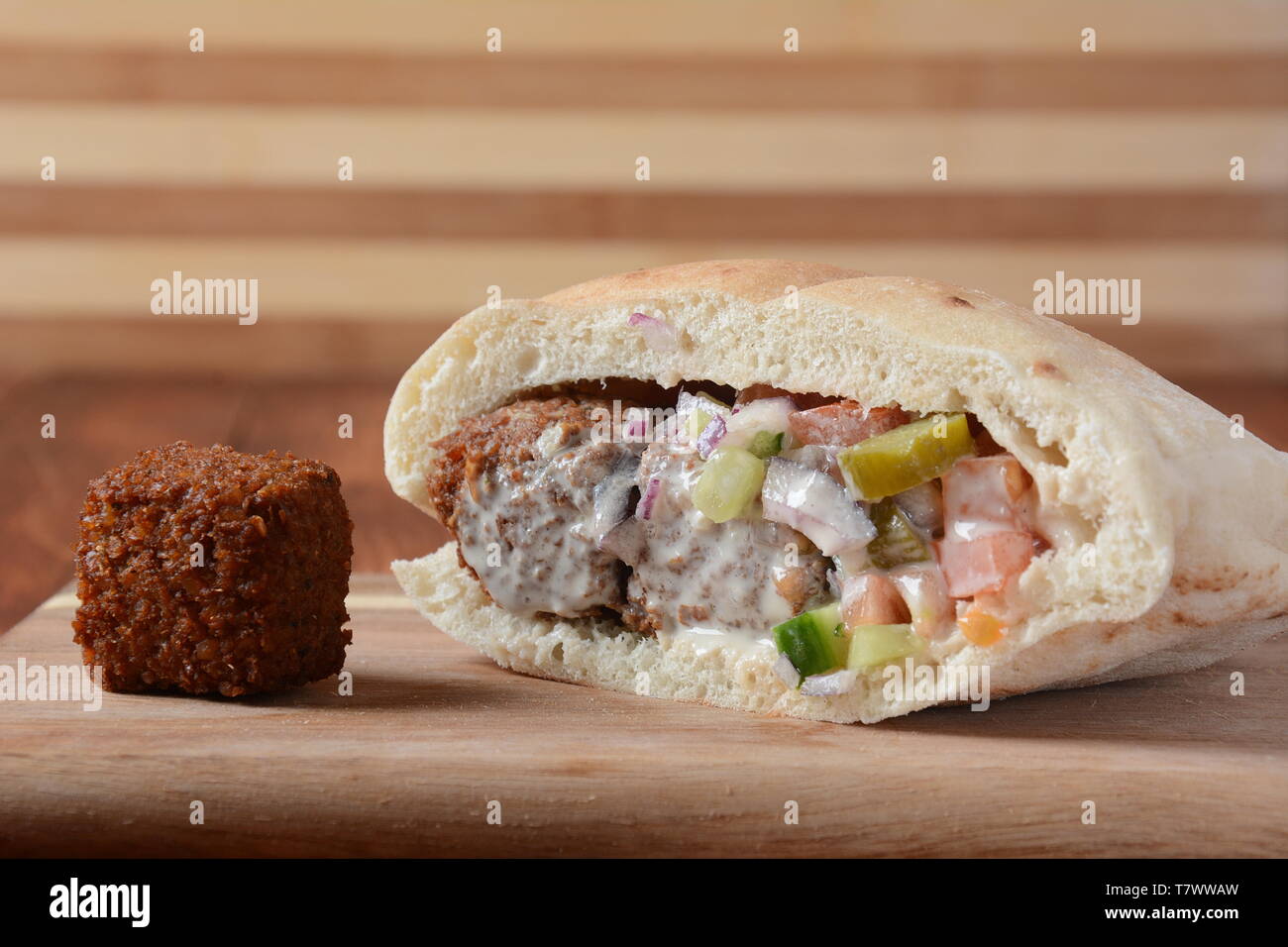 Falafel in pita bread with vegetable salad, harissa sauce, humus ...