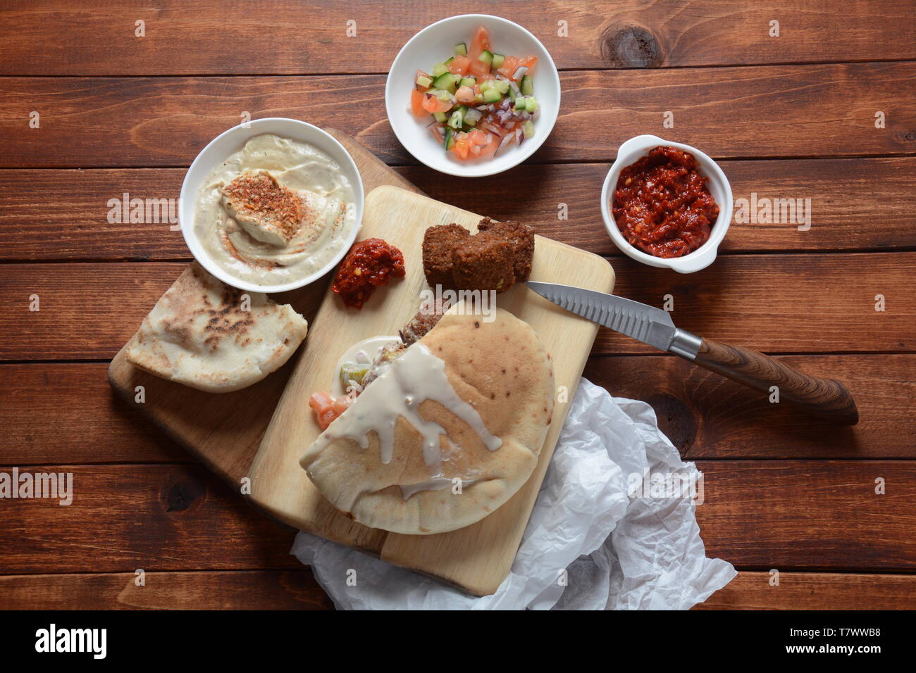 Falafel in pita bread with vegetable salad, harissa sauce, humus ...