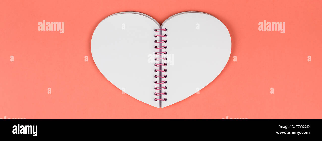 Creative top view flat lay of heart shaped notepad with blank pages as ...