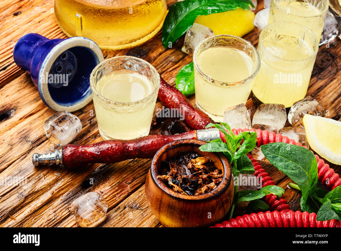Smoking shisha and glasses with alcoholic limoncello.Hookah and alcohol ...