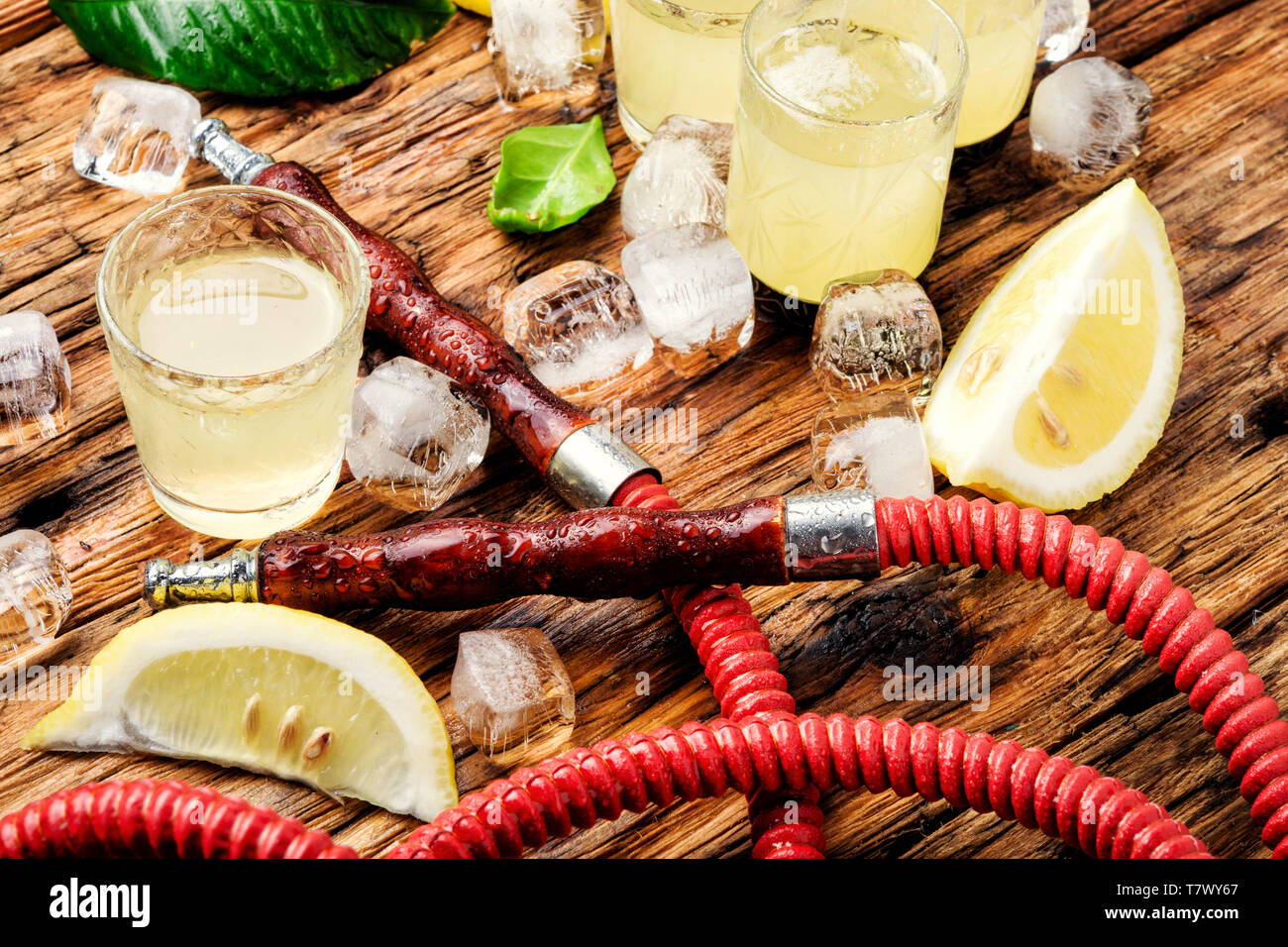 Smoking shisha and glasses with alcoholic limoncello.Hookah and alcohol ...