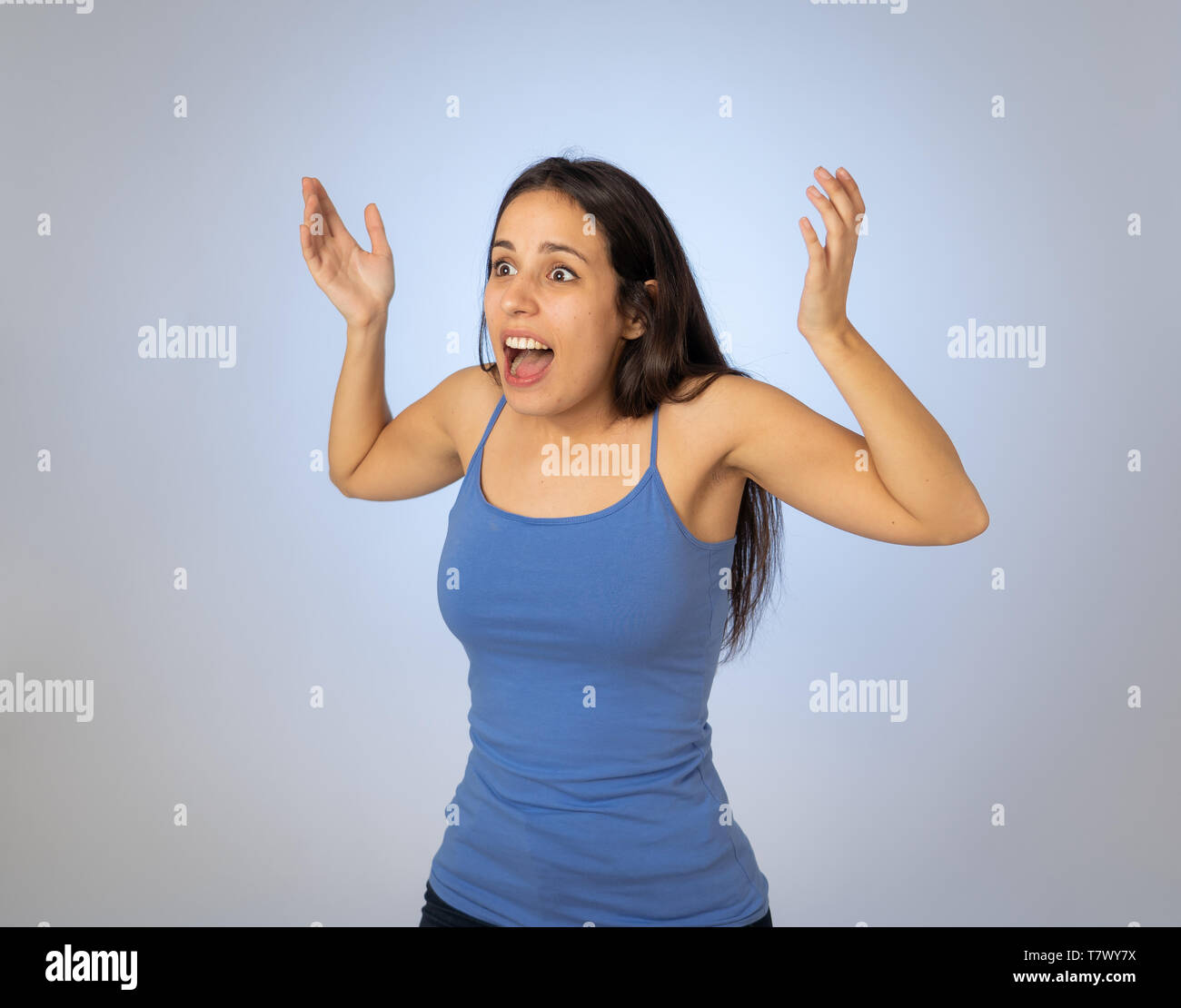 Portrait of beautiful shocked young latin woman surprised hearing good ...