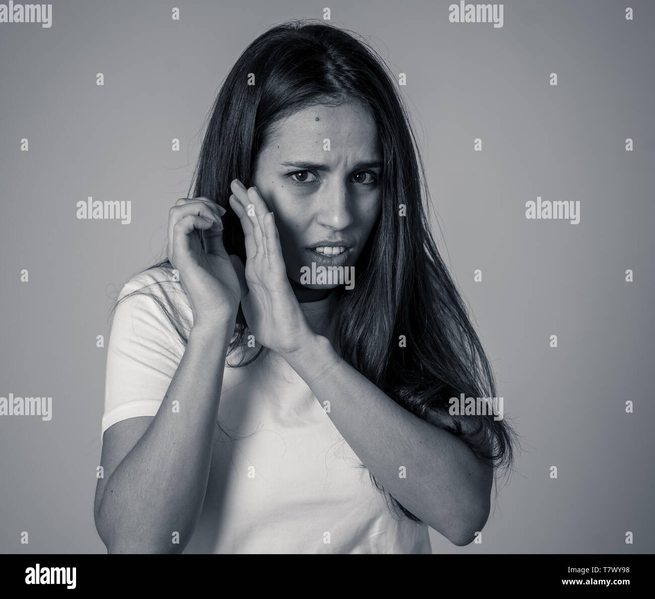 Portrait of young latin woman feeling scared and shocked making fear ...