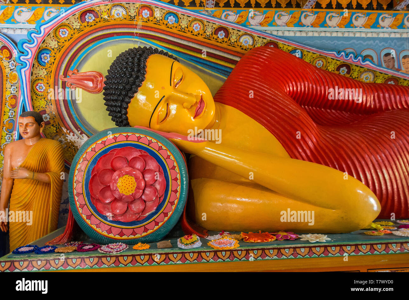 Head detail view of the colourful reclining statue of Buddha in the ...