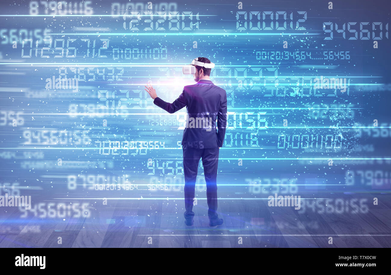 Businessman in vr glasses with variable fast changing numbers around ...