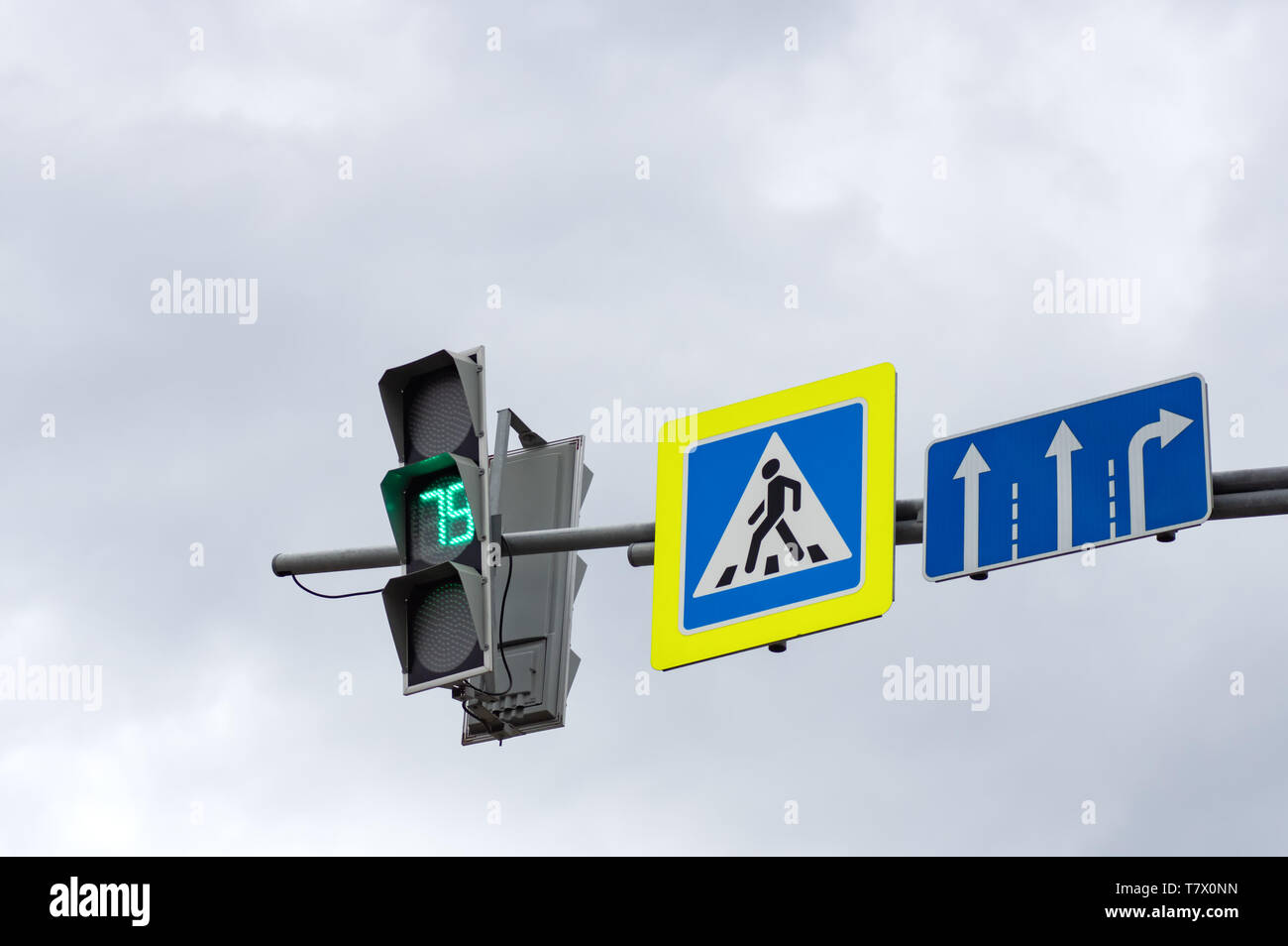 Green color on the traffic light. Sign of a pedestrian crossing. Road ...