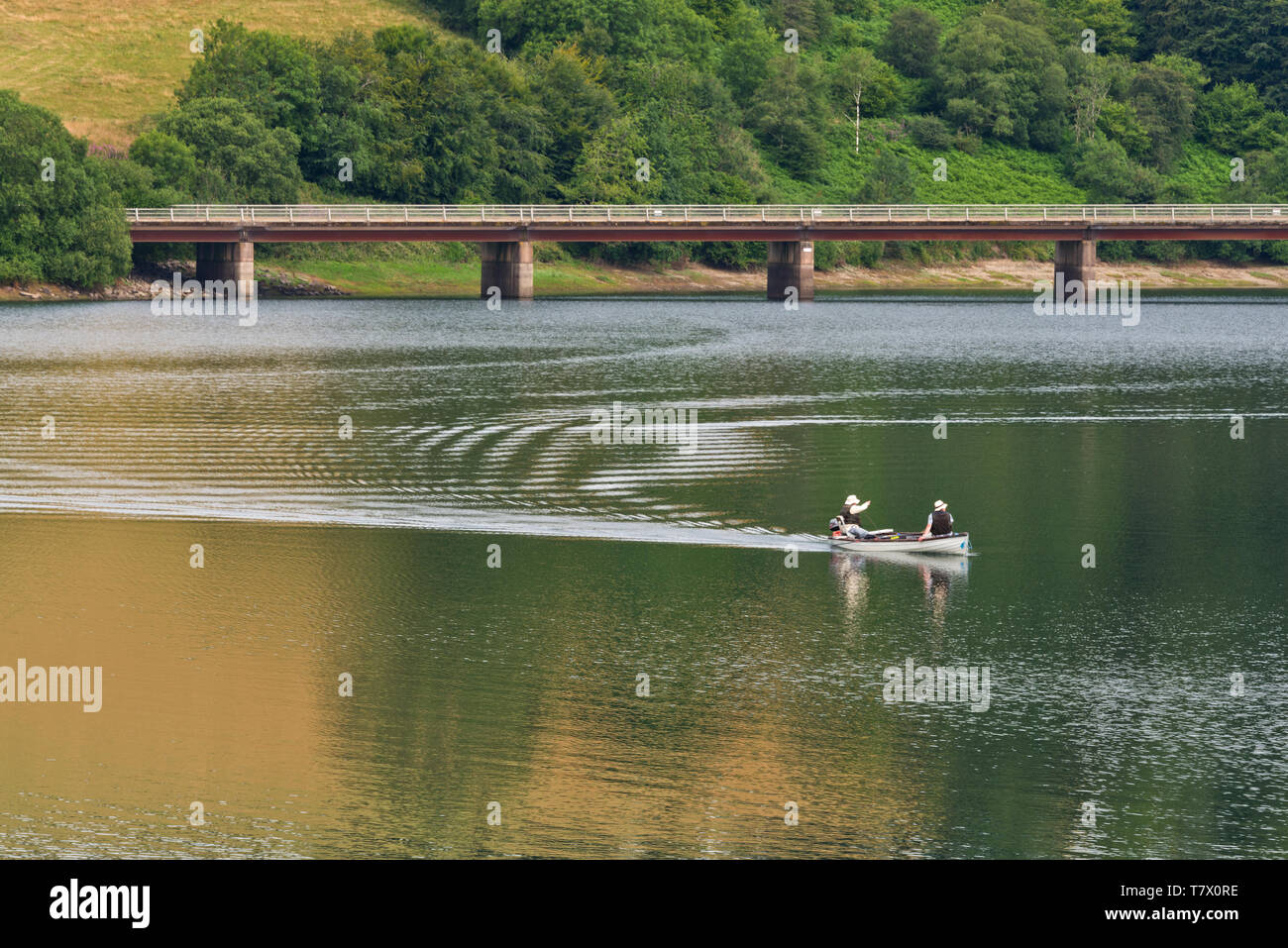 Anglers out on Wimbleball lake with Bessom Bridge in the background ...