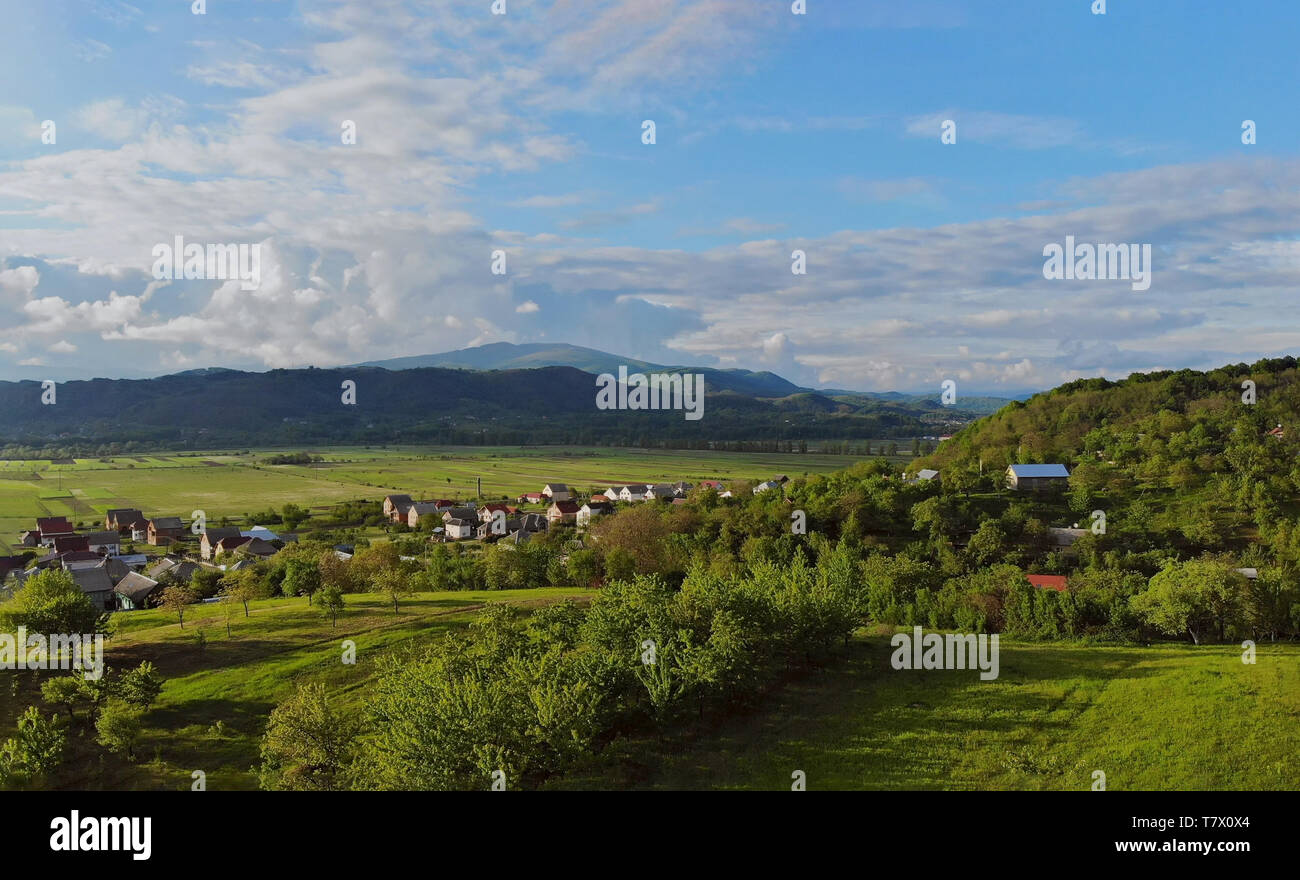 Aerial view of small village surrounded by mountains Karpaty Ukraine ...