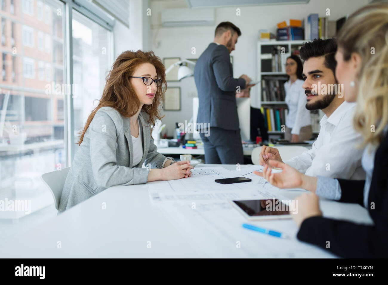 Young smart business people meeting in business office Stock Photo - Alamy