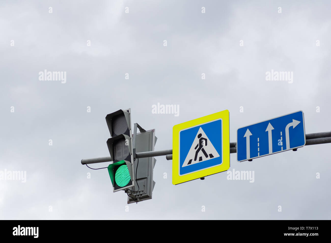 Green color on the traffic light. Sign of a pedestrian crossing. Road ...