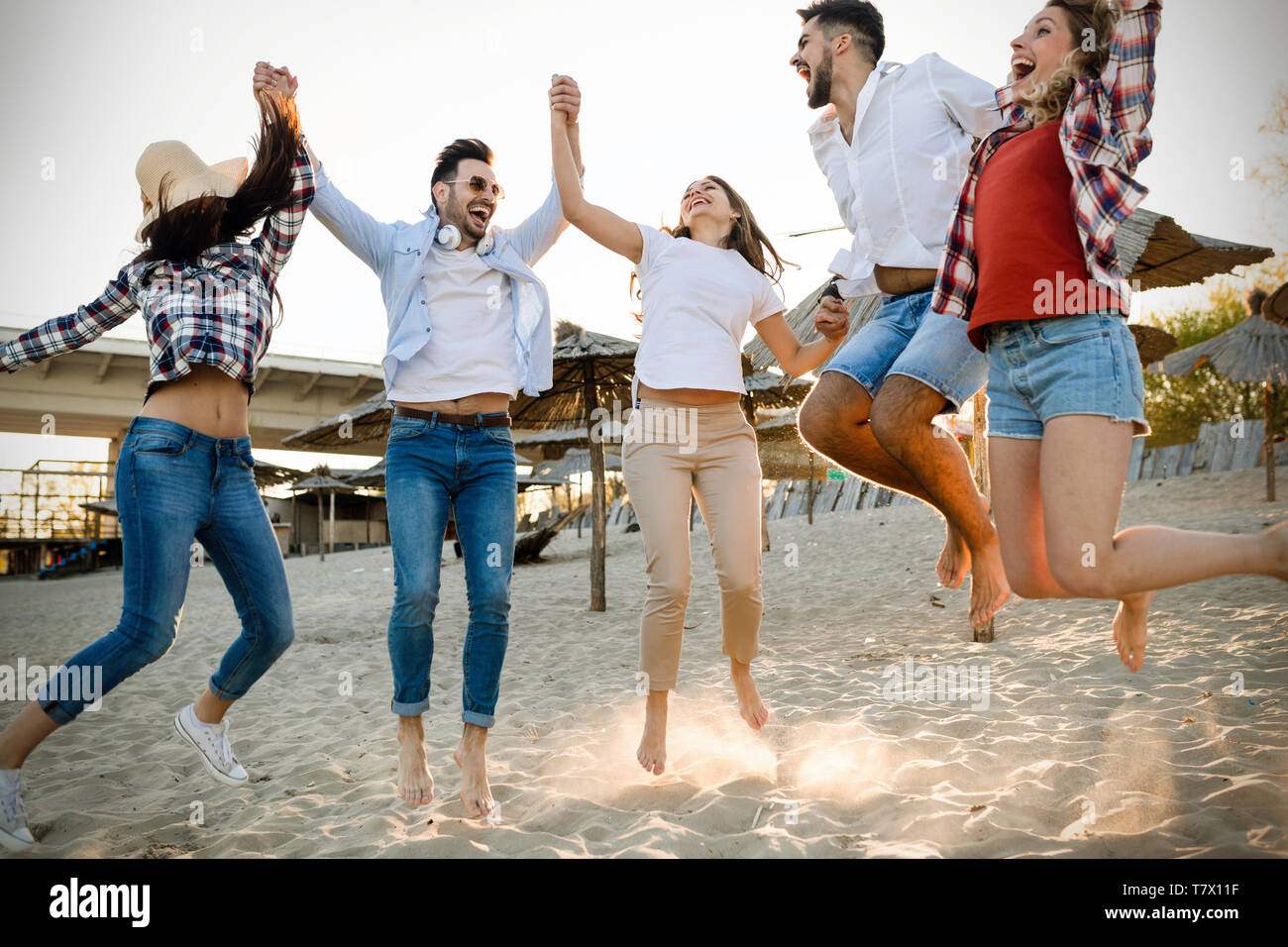 Group of friends on beach having fun Stock Photo - Alamy
