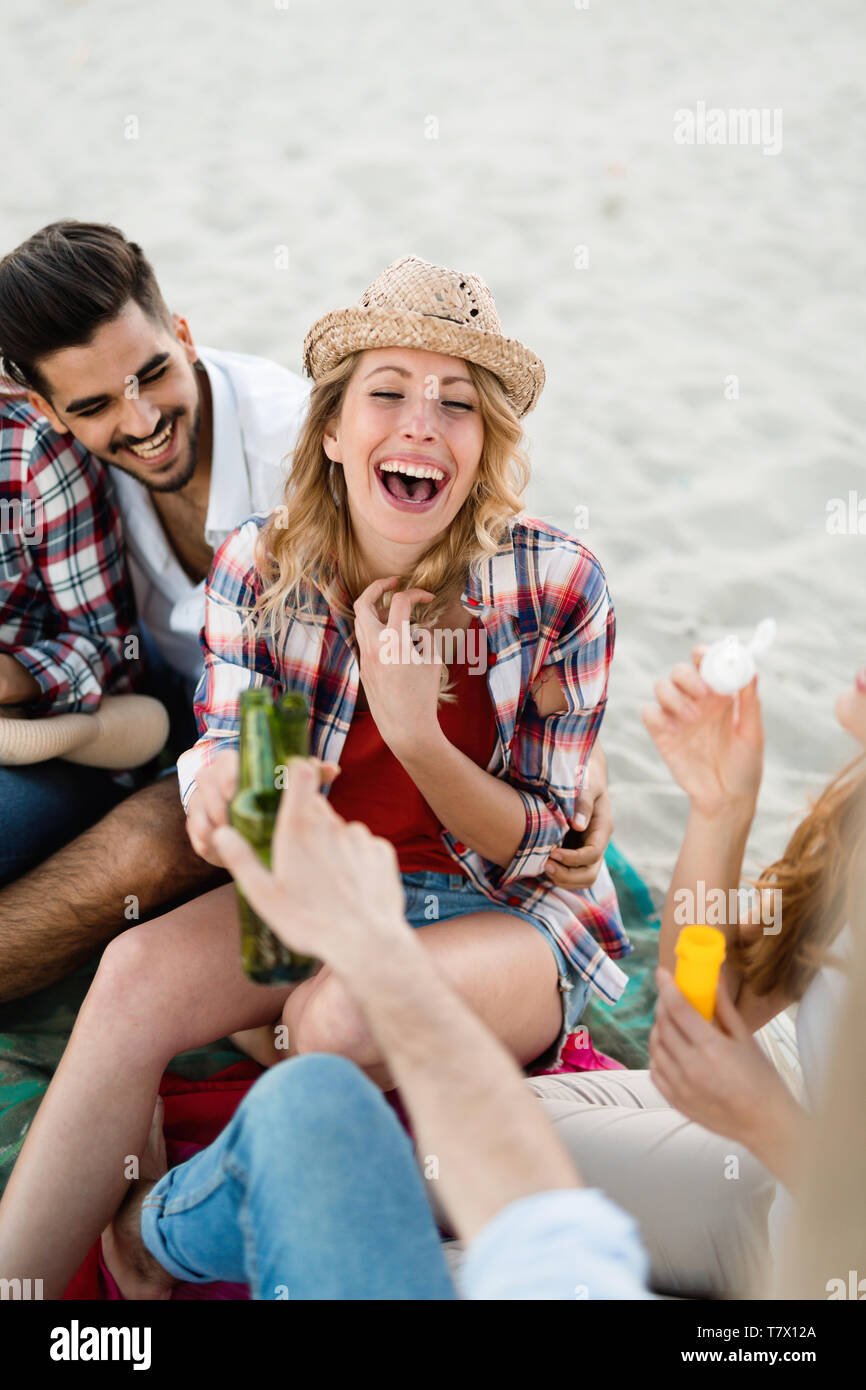 Beach party with friends. Cheerful young people spending nice time ...