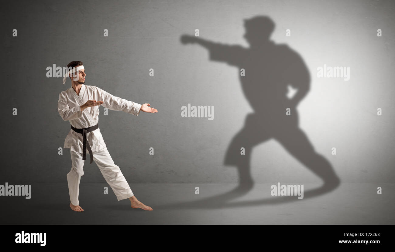 Young karate man confronting with his own shadow Stock Photo - Alamy